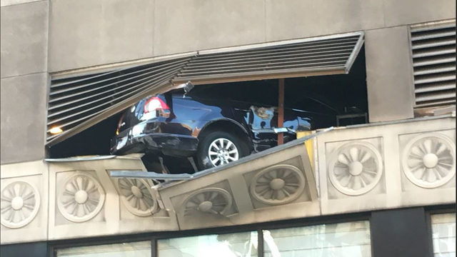 Car dangles from second floor of parking garage after crash | WPXI